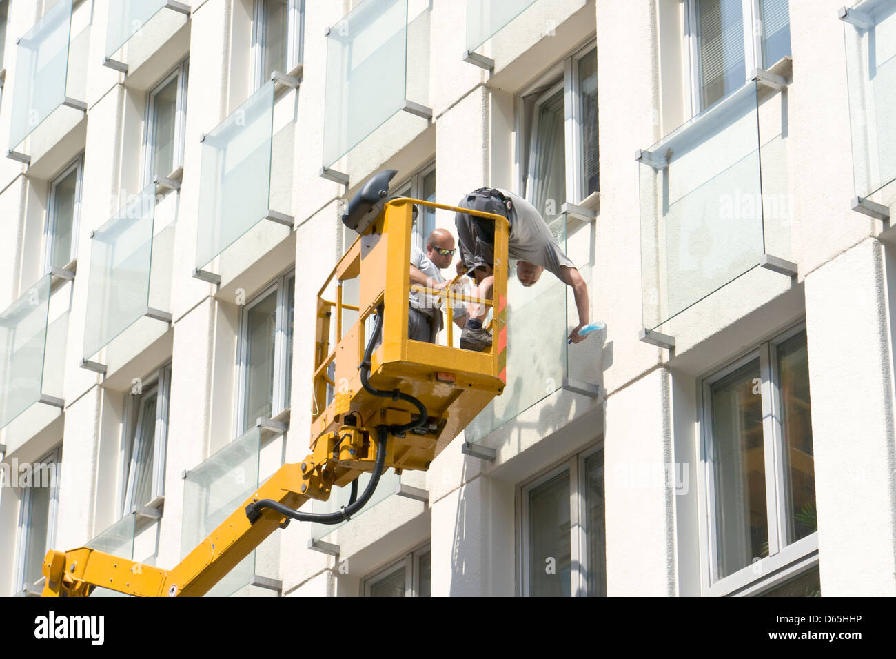 Window cleaners on aerial platform Stock Photo - Alamy