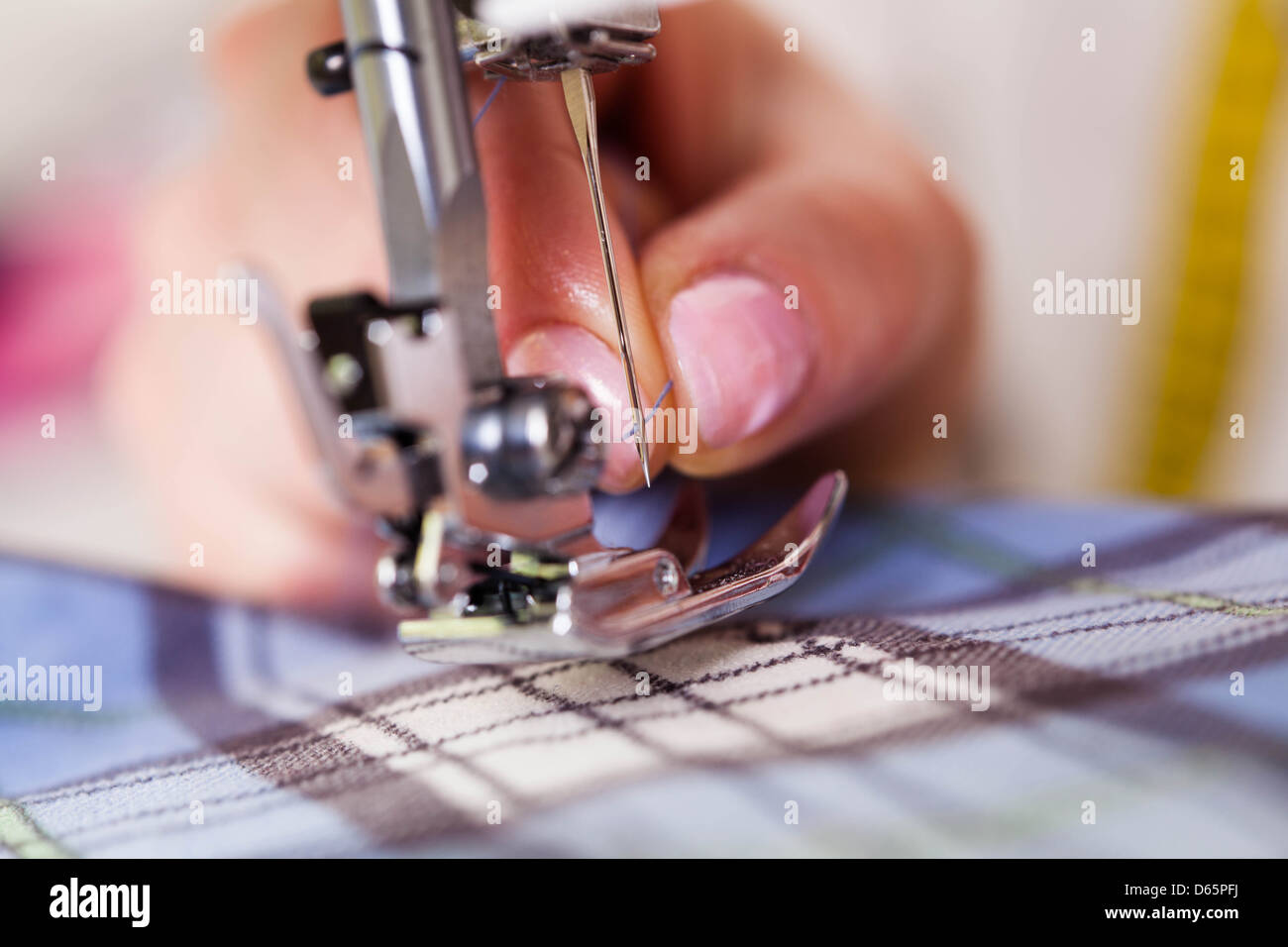 A sewer threding a needle Stock Photo - Alamy