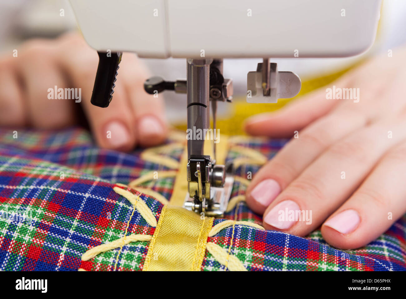 A sewer making a stitch on the fabric Stock Photo - Alamy