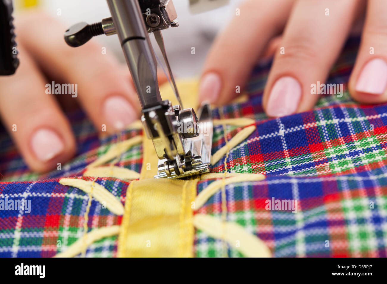 A sewer making a stitch on the fabric Stock Photo - Alamy