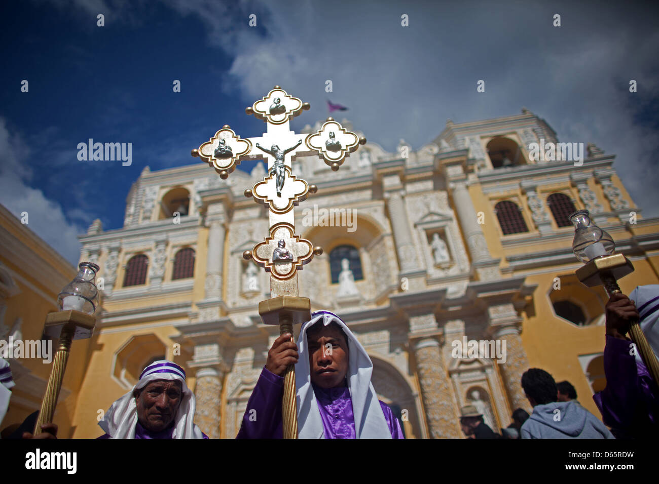 A penitent holds a cross in front of La Merced church before an Easter ...