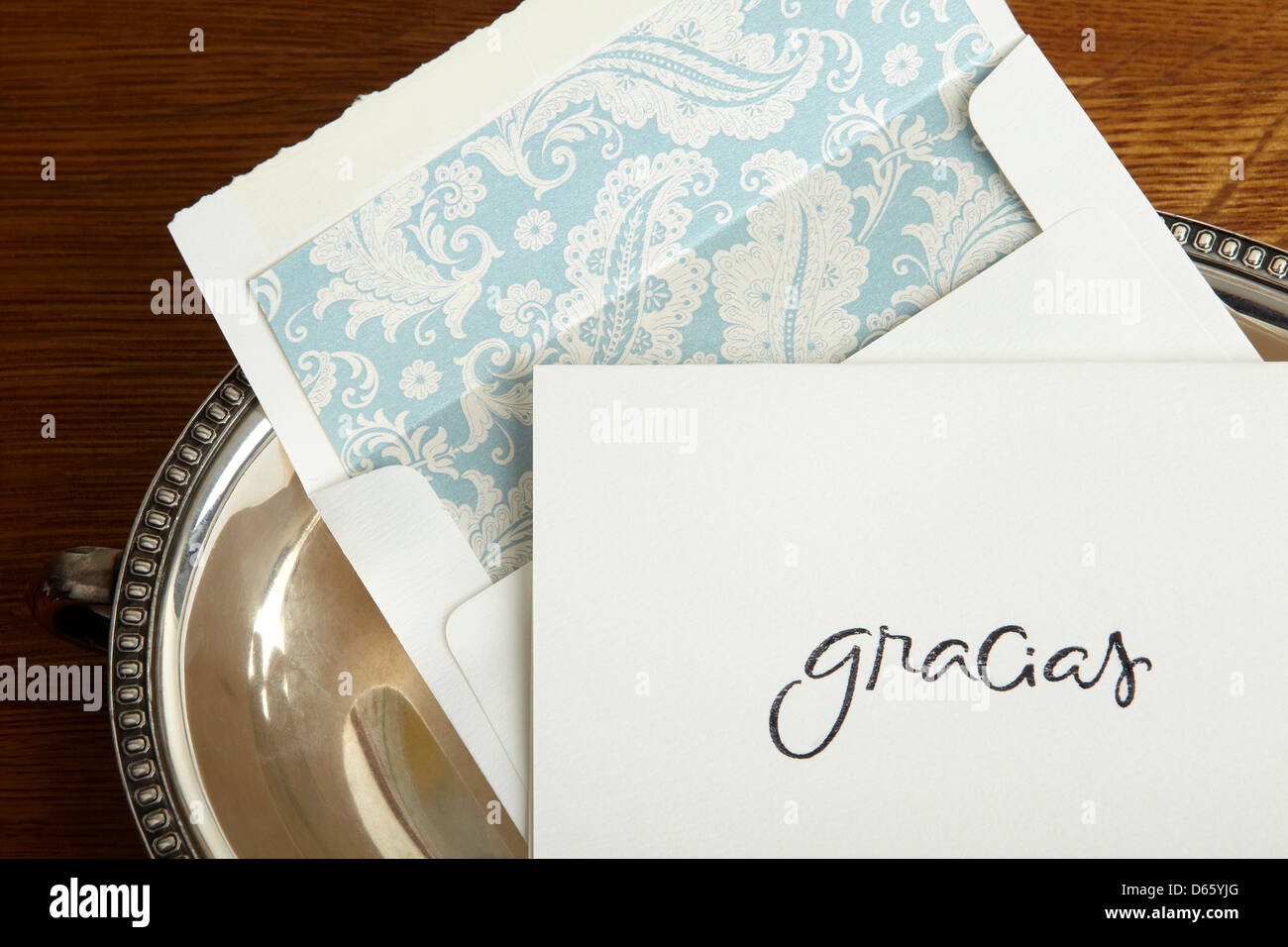 Gracias, thank you note on silver tray Stock Photo - Alamy