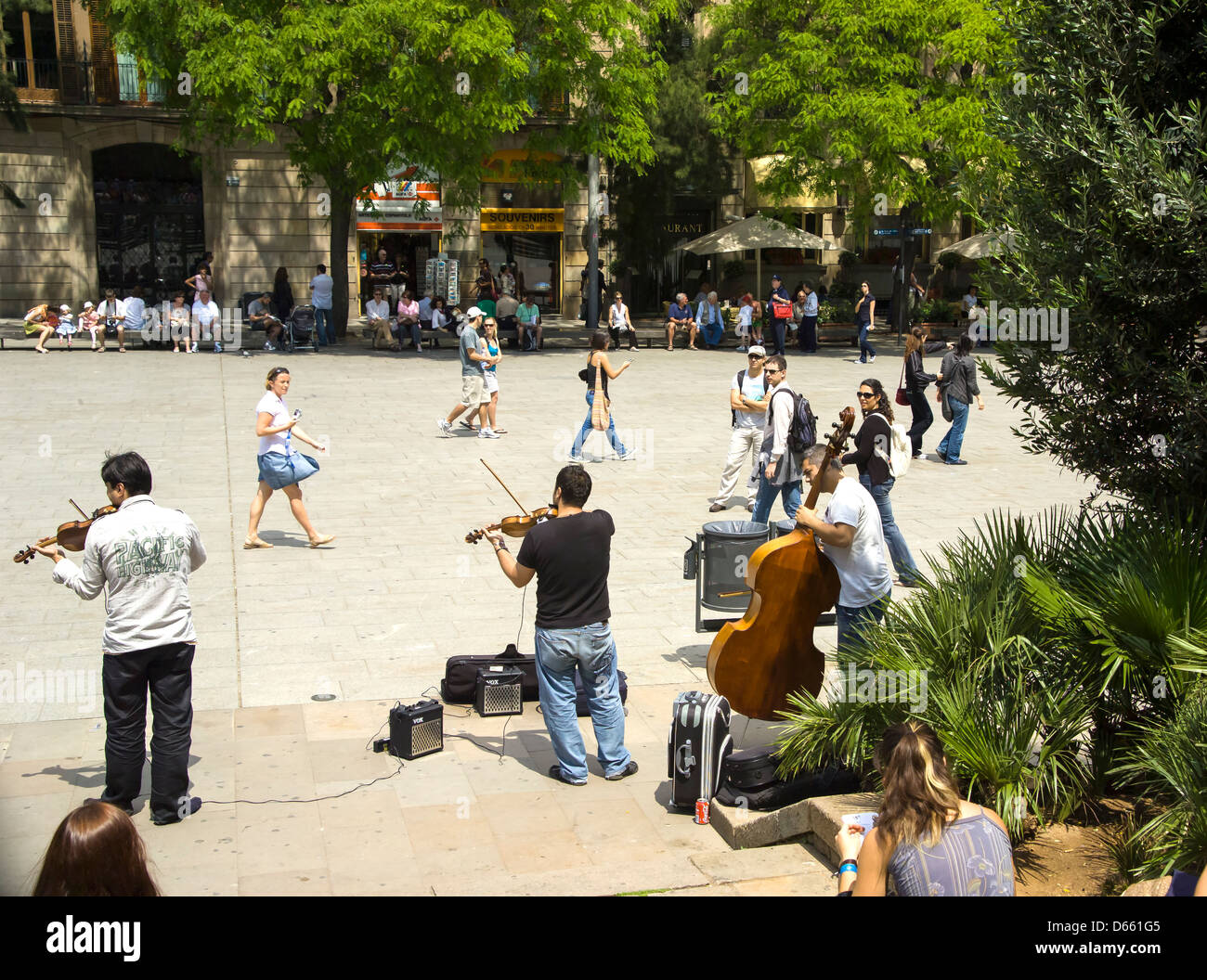Barcelona street musicians playing, rear view Stock Photo - Alamy