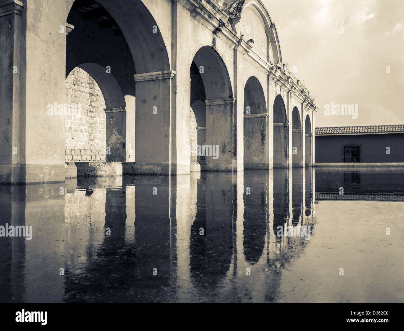 Arched structure spans waterway. Arches are reflected in water Stock ...