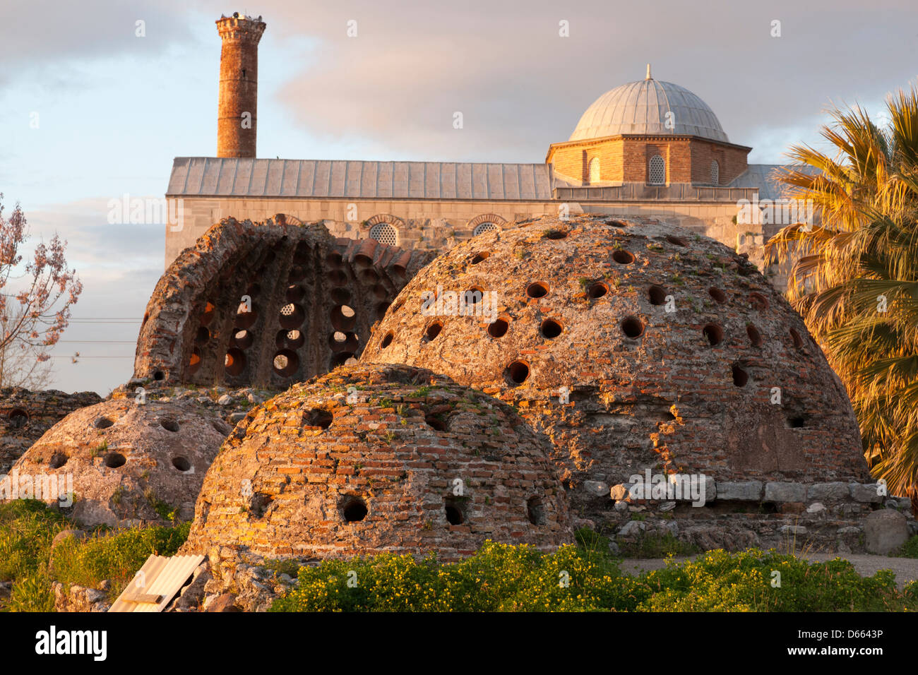 Domes of an ancient ruined Turkish bath in front of the Isa Bey Mosque ...