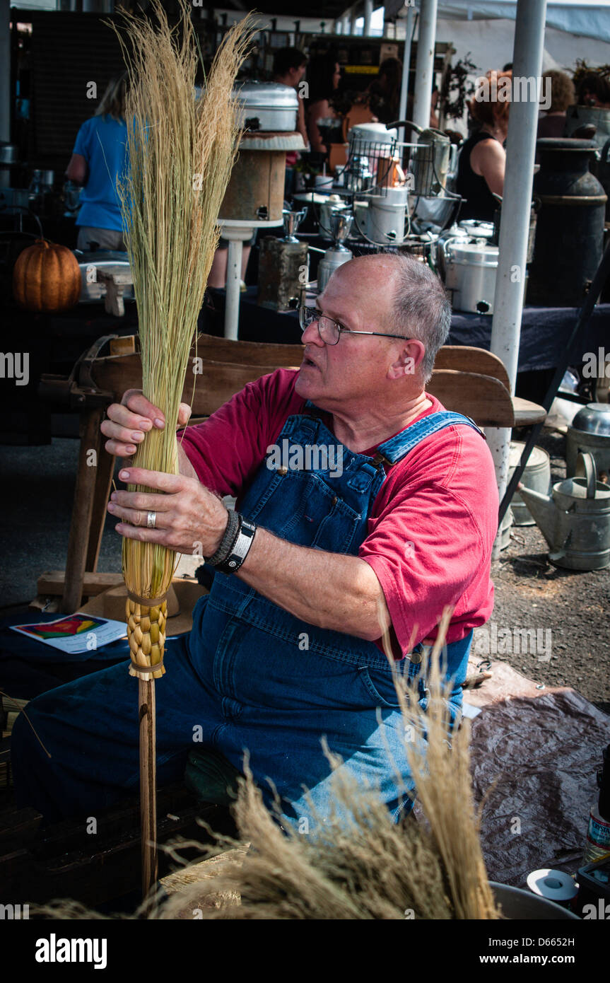 Craftsman assembling handmade brooms Stock Photo - Alamy