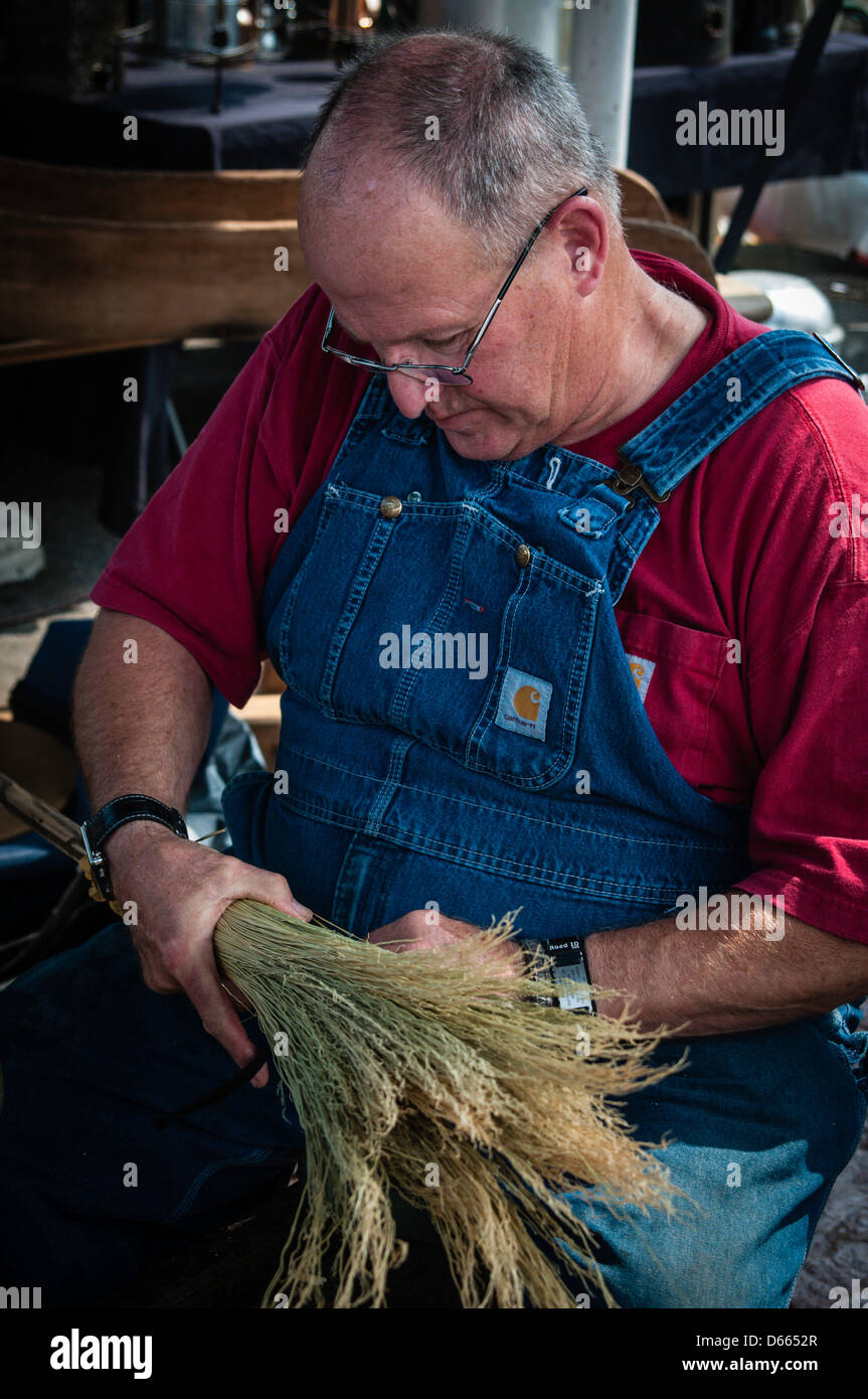 Craftsman assembling handmade brooms Stock Photo - Alamy