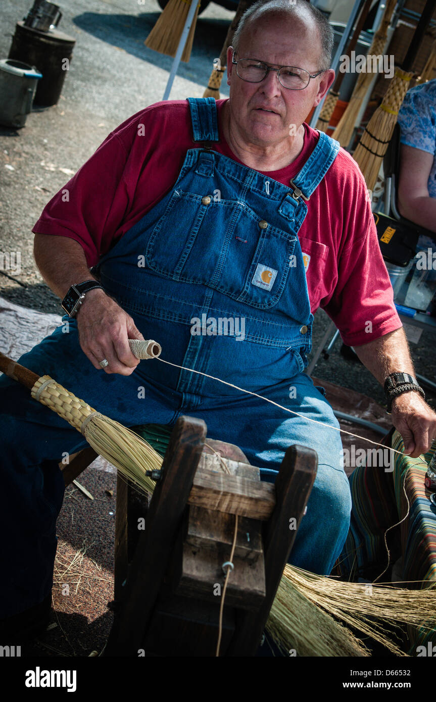 Craftsman assembling handmade brooms Stock Photo - Alamy