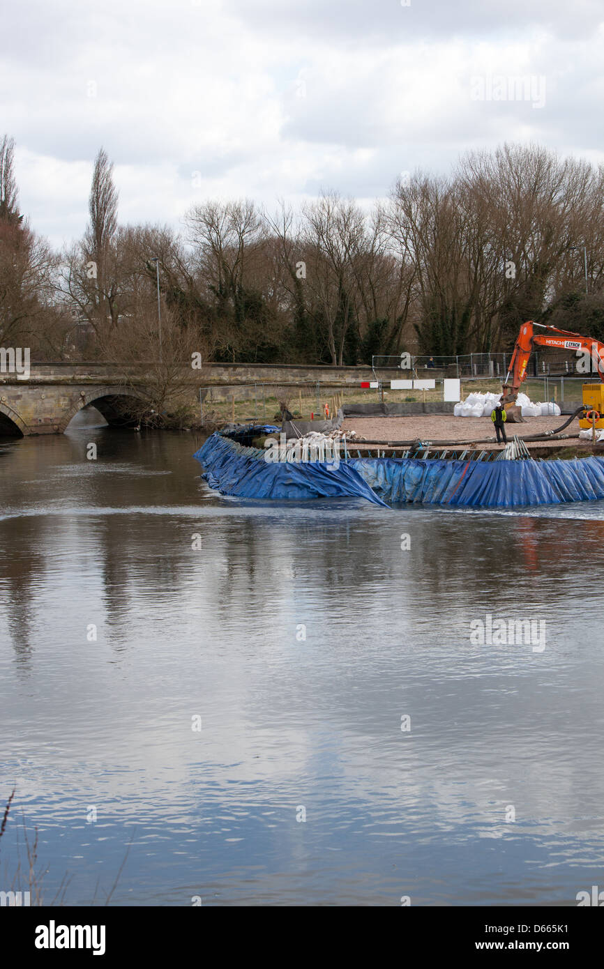 A mechanical digger working on a riverside construction project Stock ...