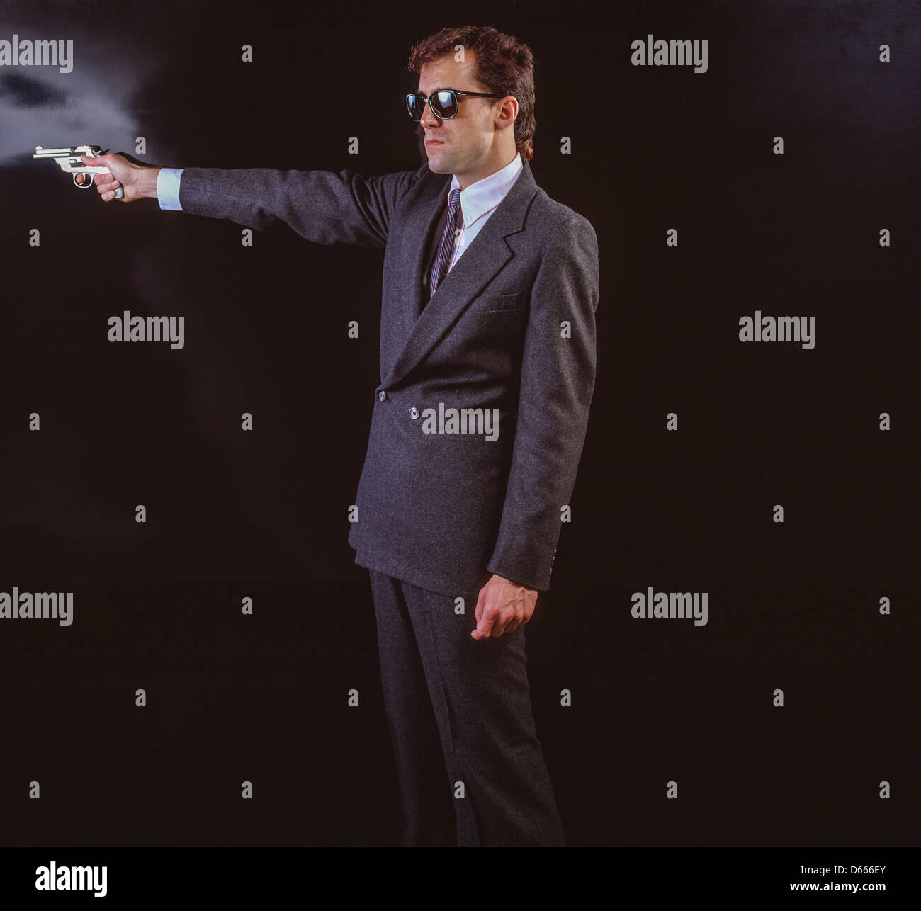 Man with handgun, pistol Stock Photo - Alamy