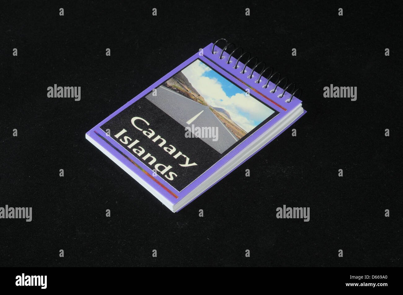 Notebook in violet with a black background Stock Photo - Alamy