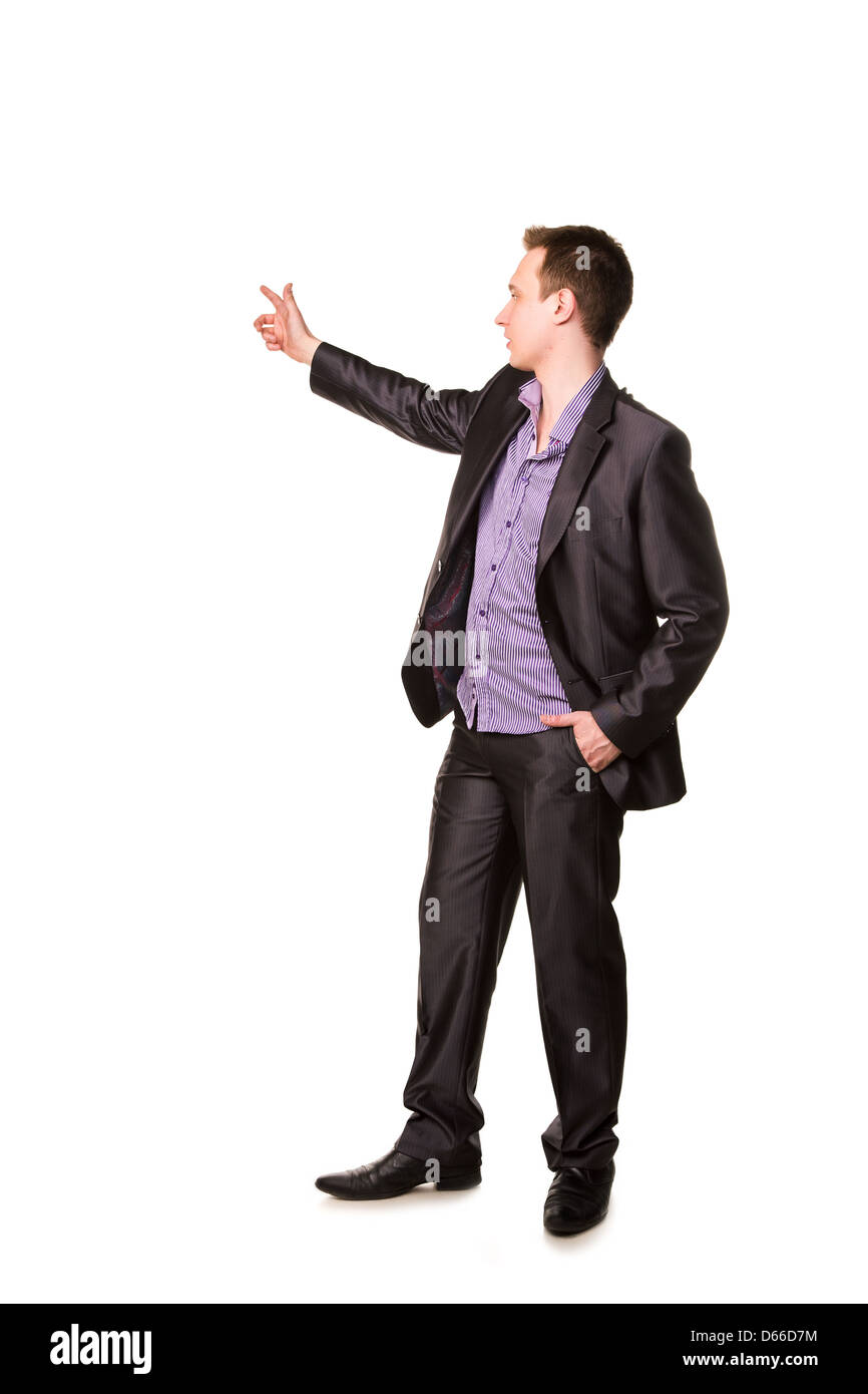 Happy young friendly smiling businessman pointing finger isolated on ...