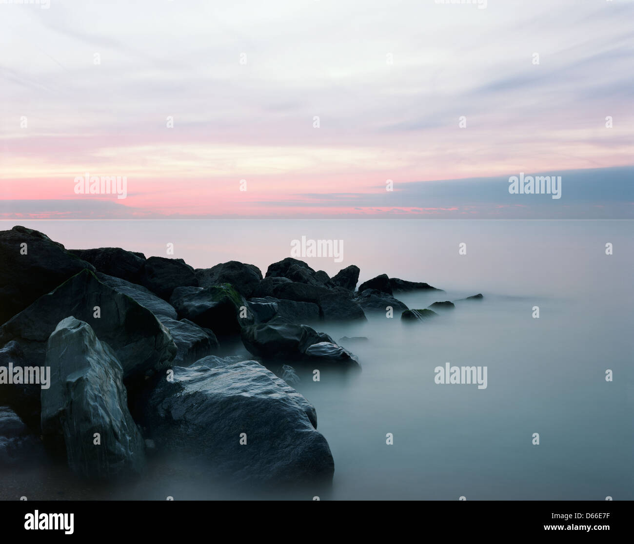 Rocks, rock groyne, sunrise Stock Photo - Alamy
