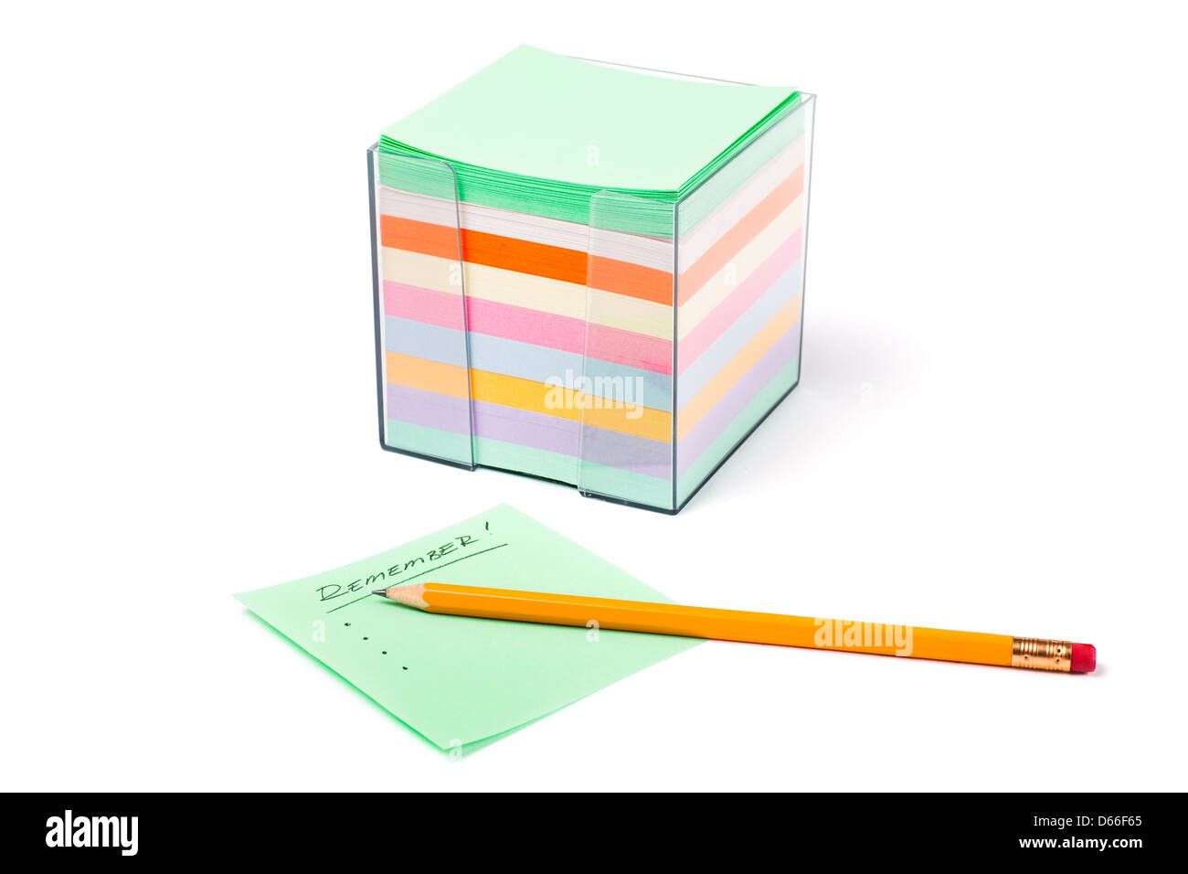 Container with note paper in different colors on white background. The ...