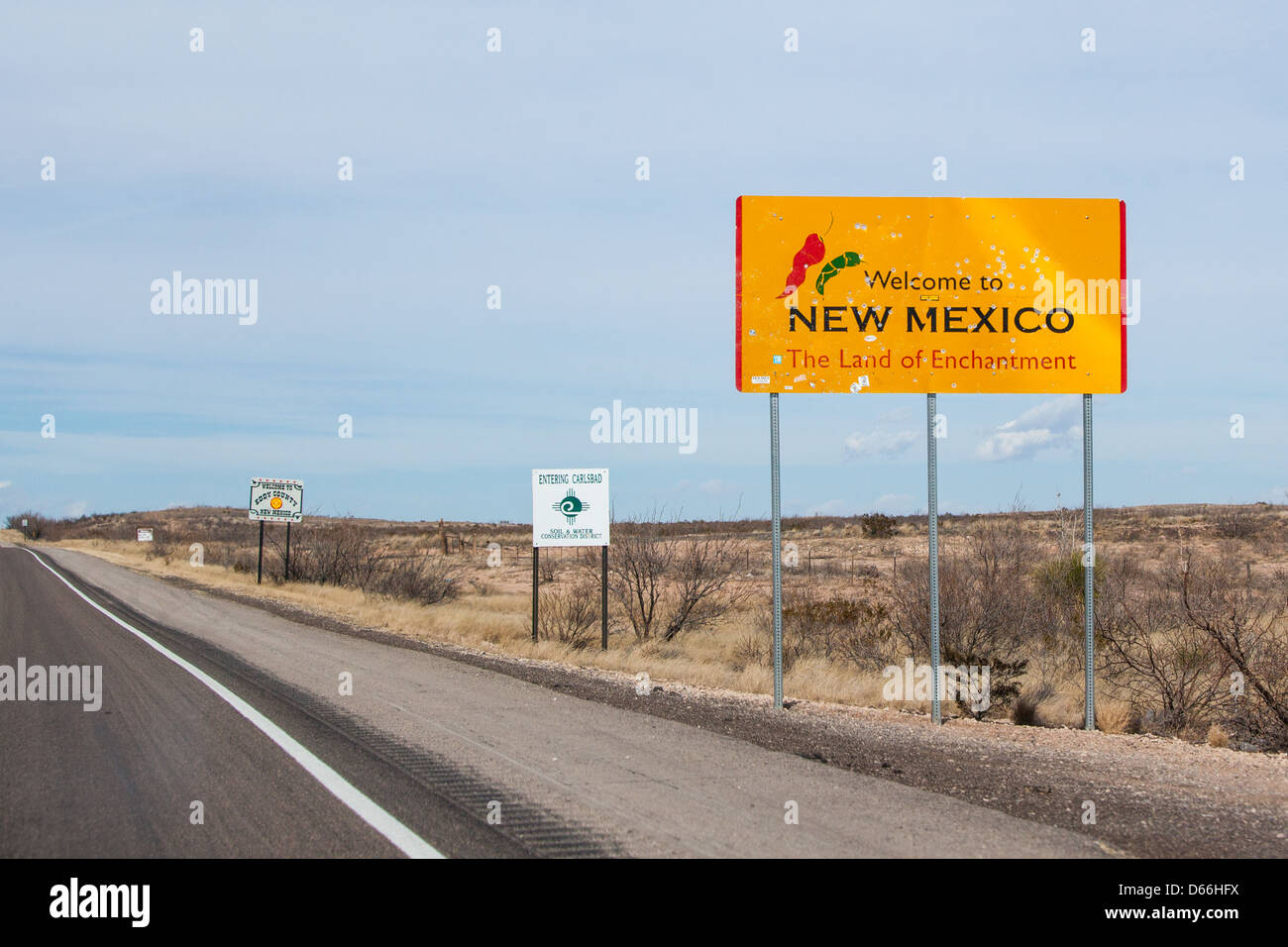 A bullet laden sign on the Pecos Hwy marking the border of New Mexico ...