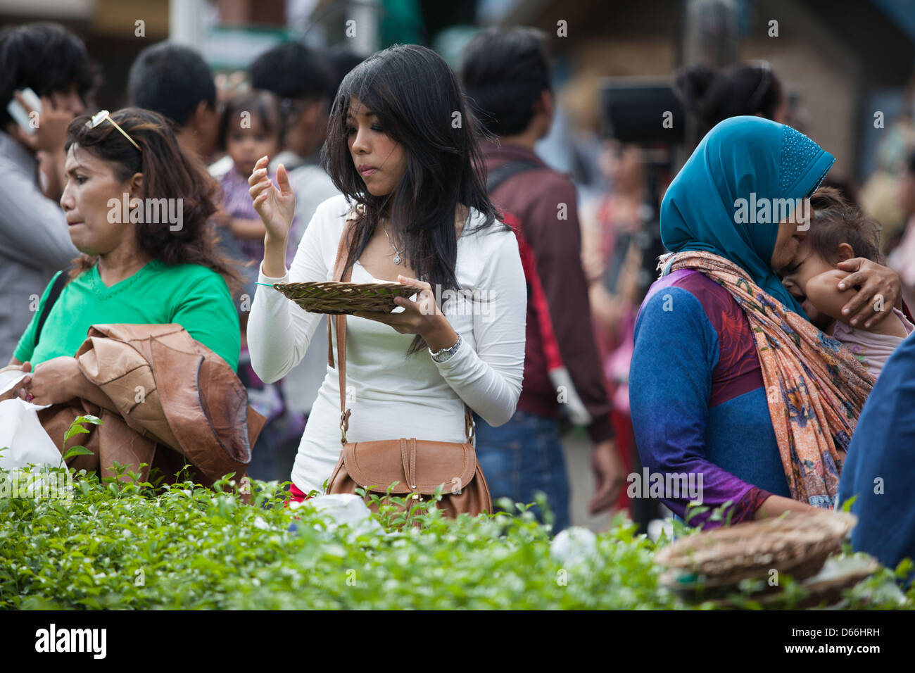 A woman enjoying her food the Bango Snack Festival-Indonesia ...