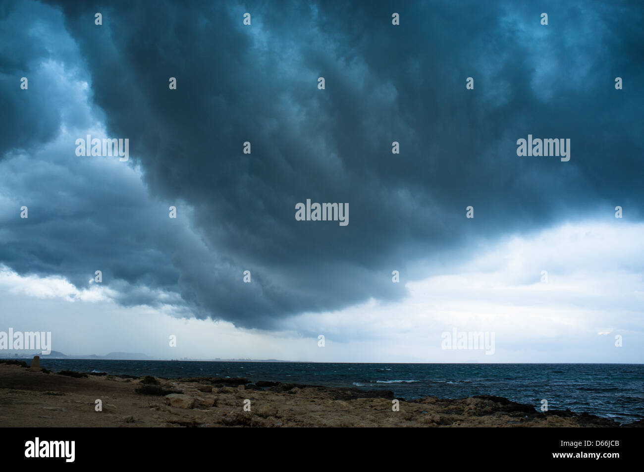 Low threatening storm clouds hanging over a coastal area Stock Photo ...