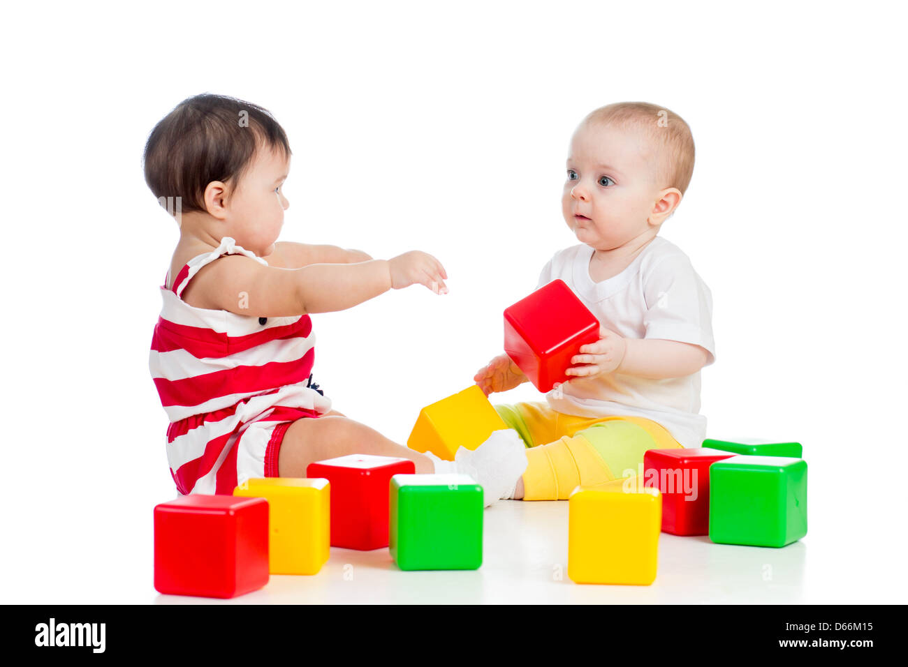 two babies or kids playing together with color toys Stock Photo - Alamy