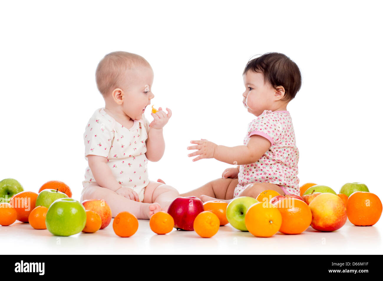 Two children kids eating together healthy food fruits isolated on white ...