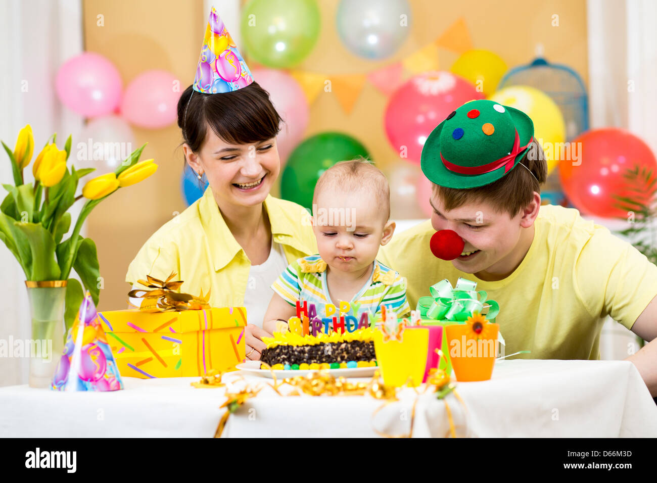 family celebrating first birthday of baby girl Stock Photo - Alamy