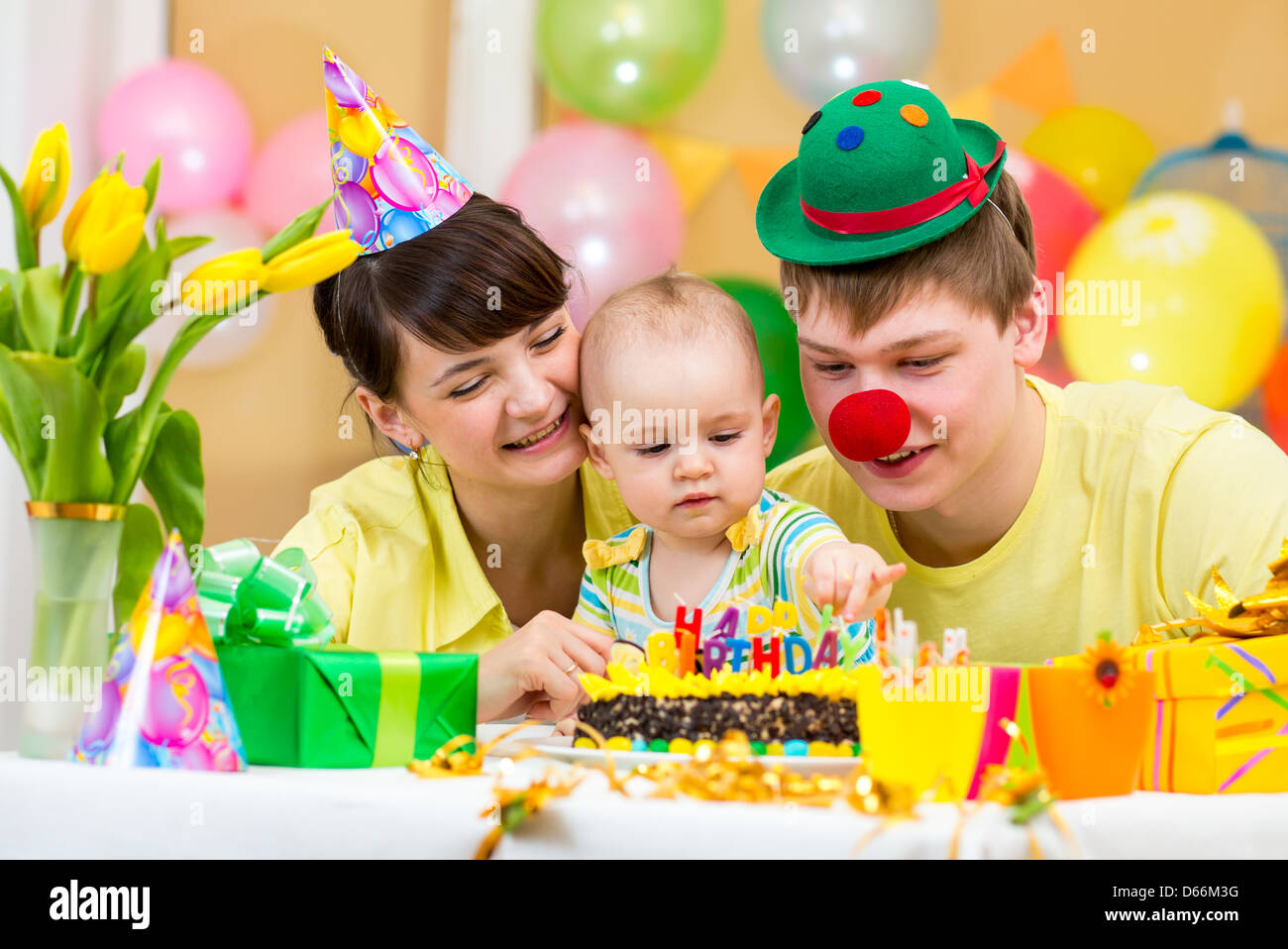 family celebrating first baby's birthday Stock Photo - Alamy