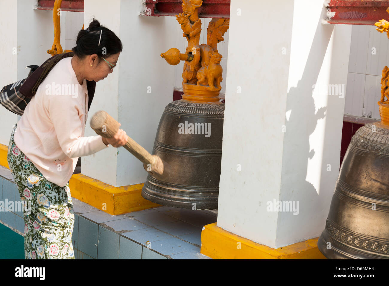 Woman ringing a bell, Mahamuni Pagoda, Mandalay, Myanmar, (Burma Stock ...