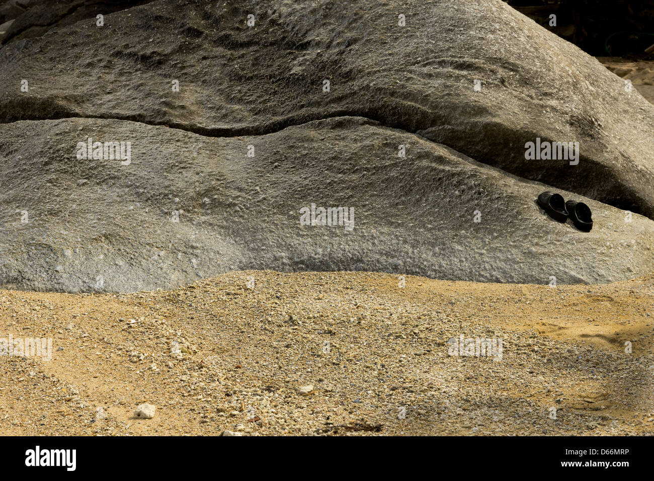 Flip-flops on a rock, Kamala Beach Stock Photo - Alamy