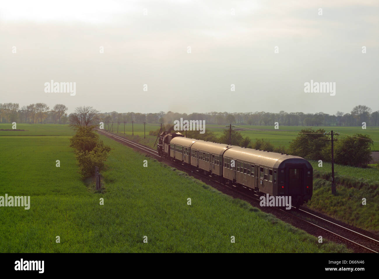 Steam retro train passing through countryside Stock Photo - Alamy