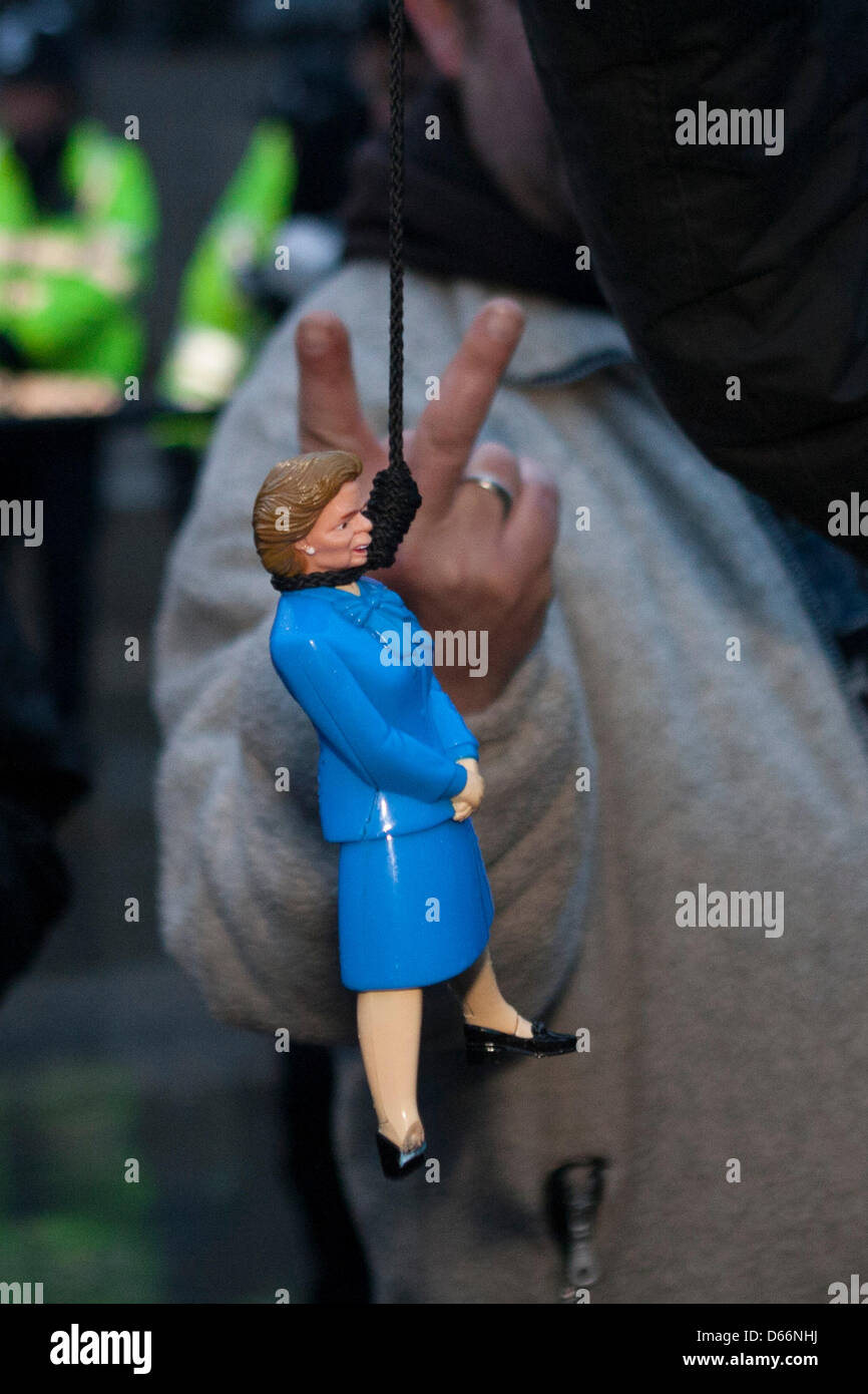 London, UK. 13 April 2013. Margaret Thatcher doll is hung while man ...