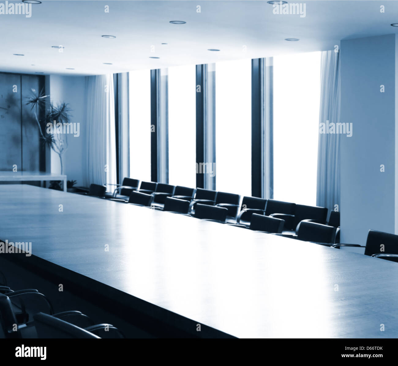 Boardroom conference room table brightly lit in blue colors Stock Photo ...