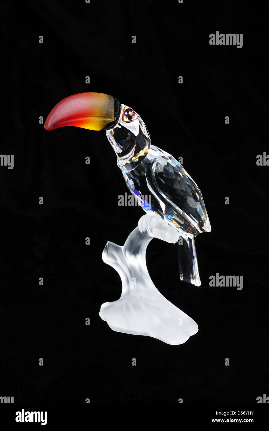 Crystal toucan against a black background Stock Photo - Alamy