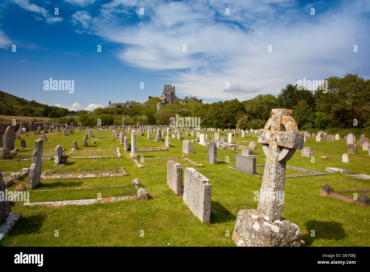 The Castle ruins as seen from the cemetery in Corfe Castle village ...