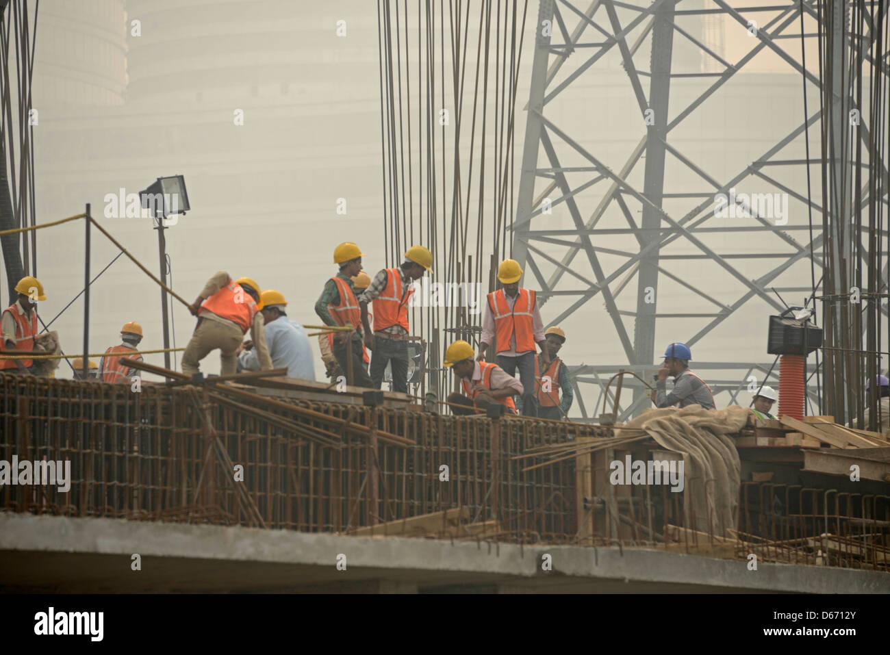 Construction workers working on an overhead metro line linking the city ...