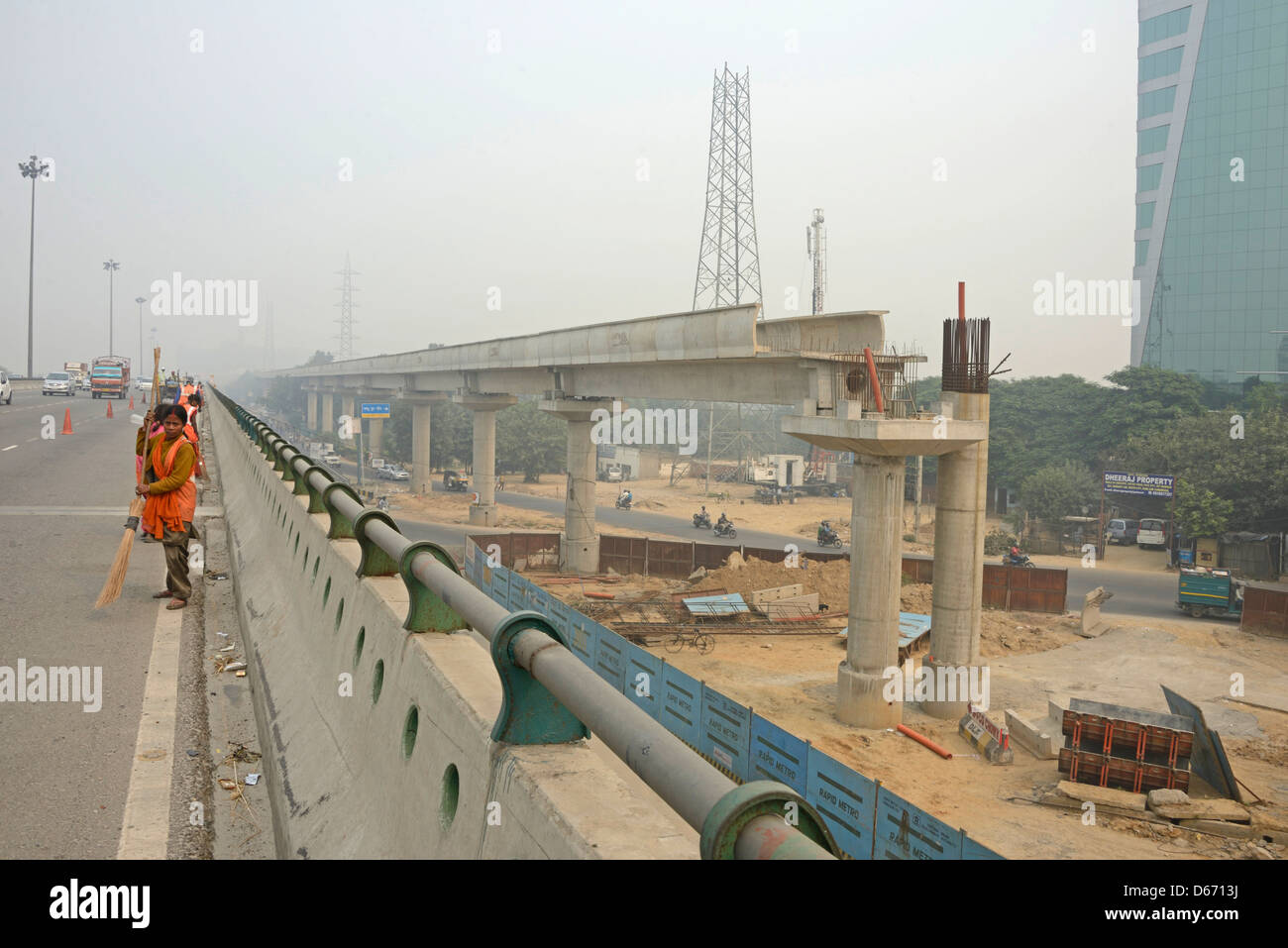 Construction workers working on an overhead metro line linking the city ...