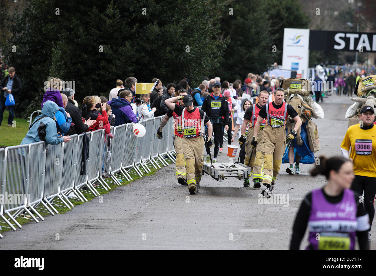 Brighton, UK, 14/04/2013 : Brighton Marathon. Fire Fighters carry a ...