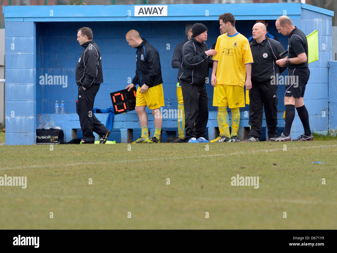 football substitute receives instructions from the coach before going ...