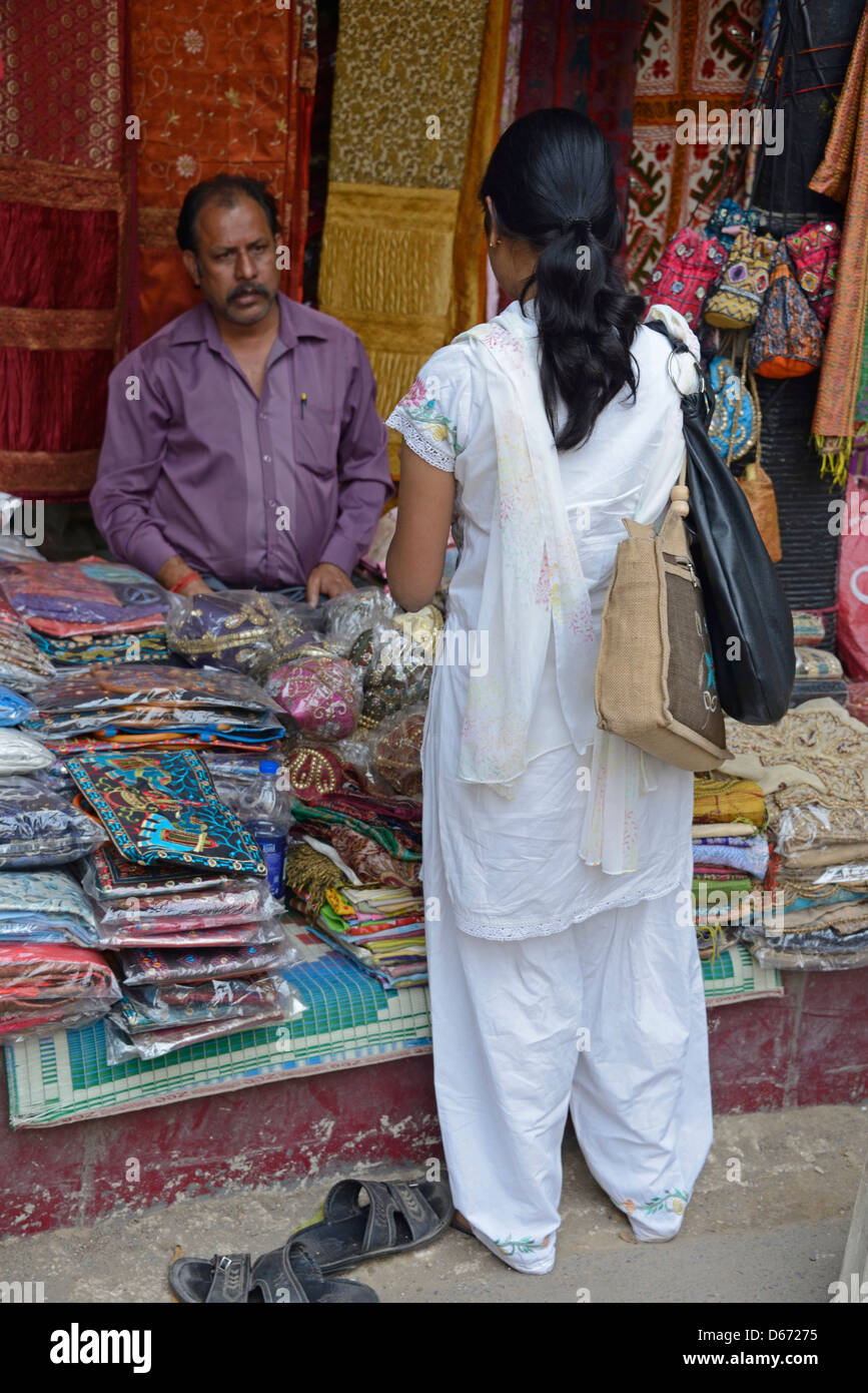 A side street market selling saris and other clothes in Janpath Lane ...