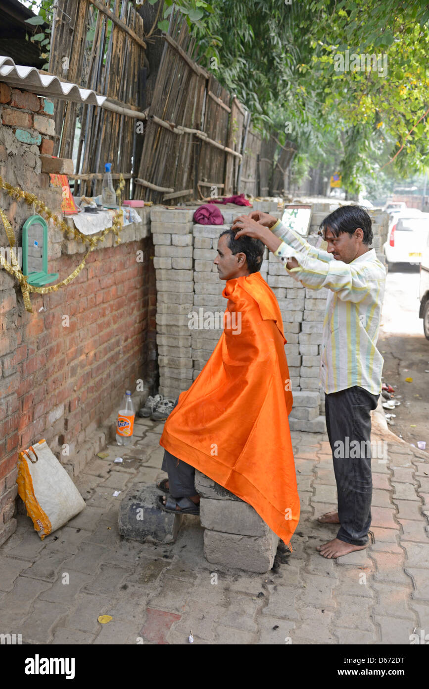 A Barber Giving His Client A Head Massage On A Street Pavement In