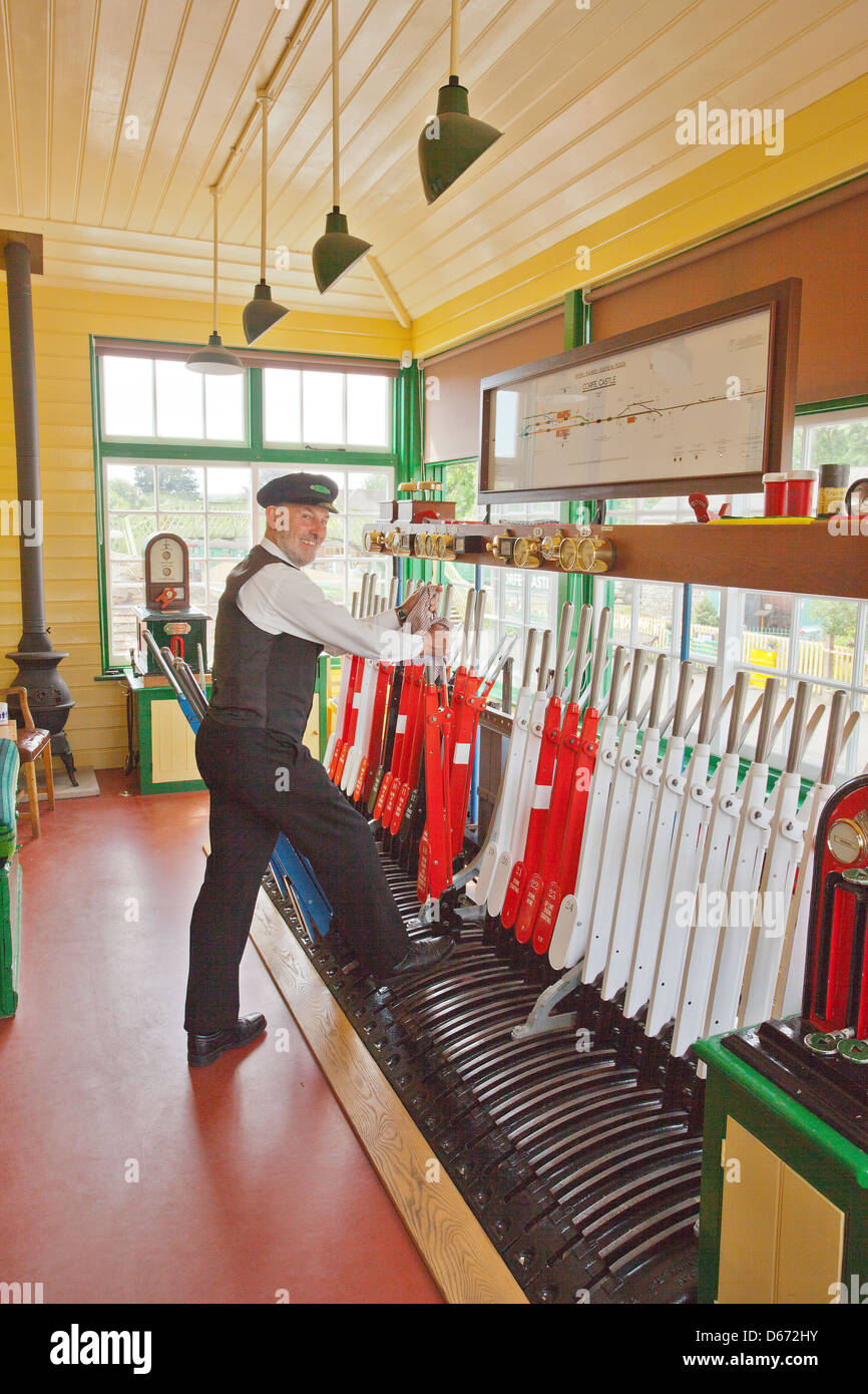 Signalman Geoff Truscott at work in the signal box at Corfe Castle ...
