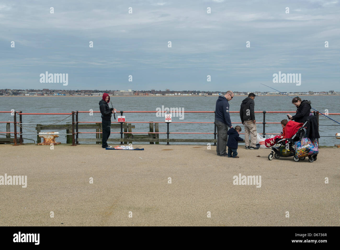 Anglers fishing at the end of Southend Pier, Essex, UK. It is the world ...