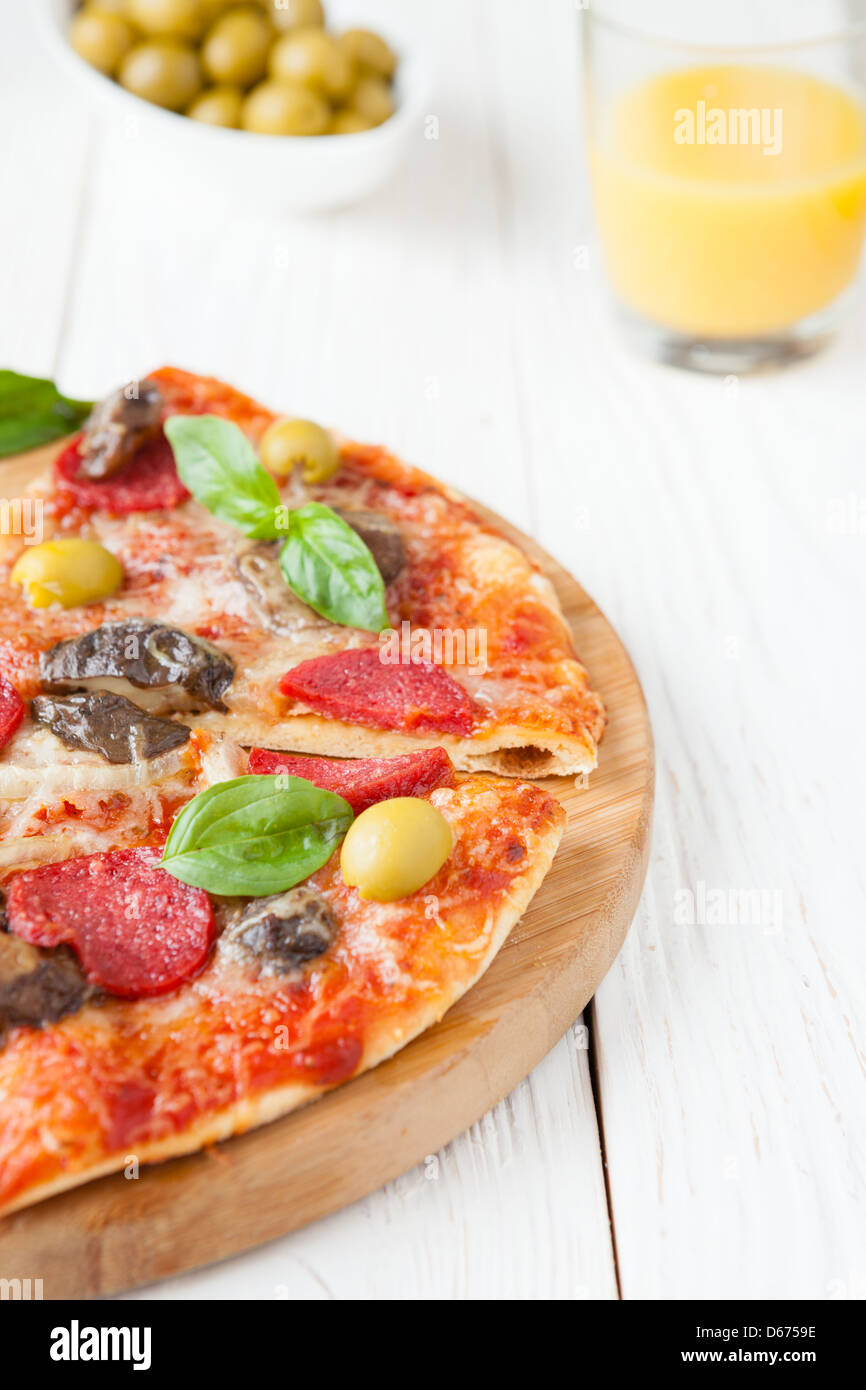 half a pizza with cheese and salami on board, closeup food Stock Photo ...