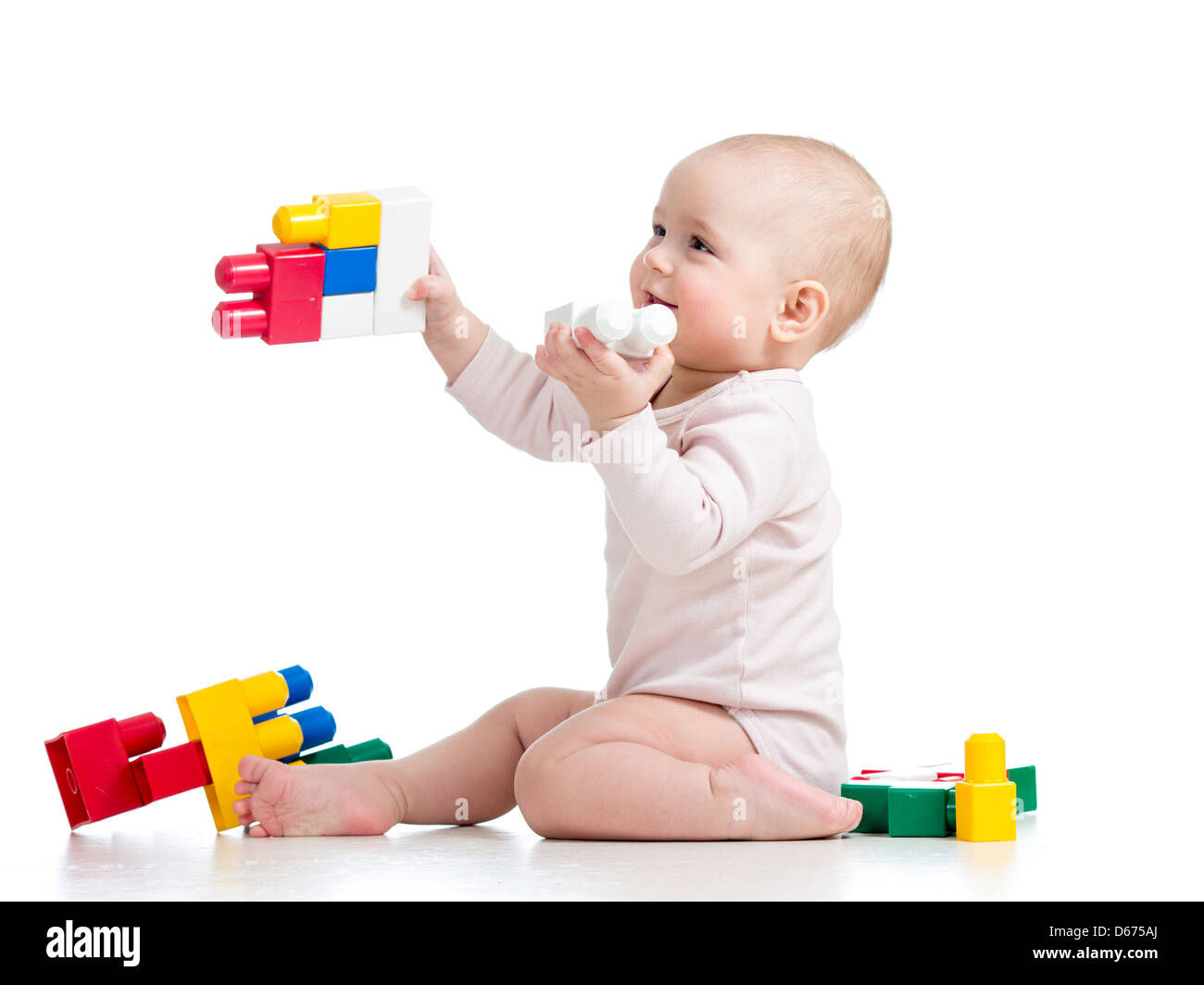 little cheerful child with construction set over white background Stock ...