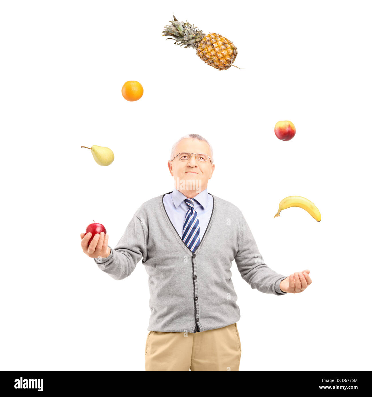 A mature man juggling fruits isolated on white background Stock Photo ...