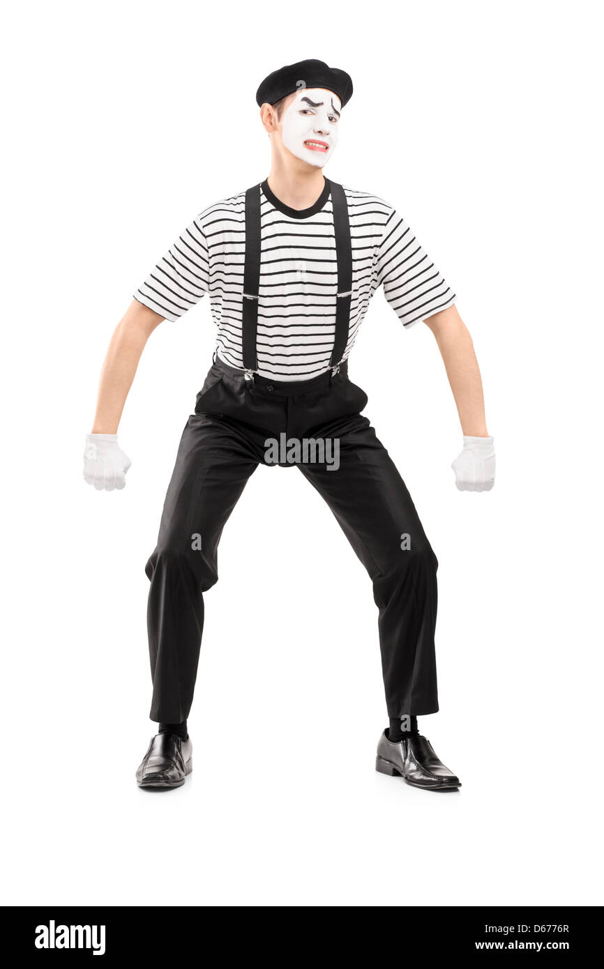 Full length portrait of a young mime artist lifting something imaginary ...