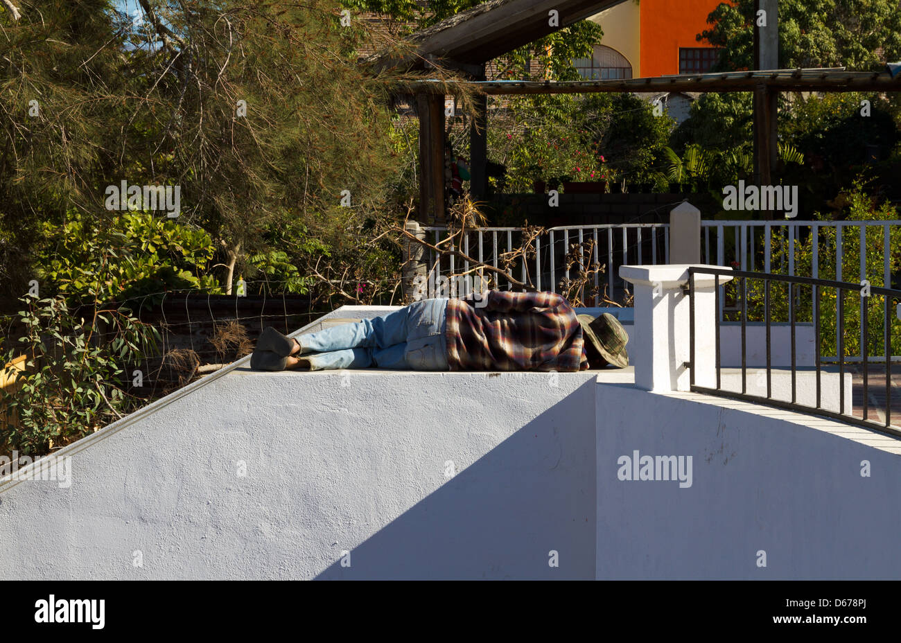 A Mexican man sleeping in the sun in Todos Santos, Mexico Stock Photo ...