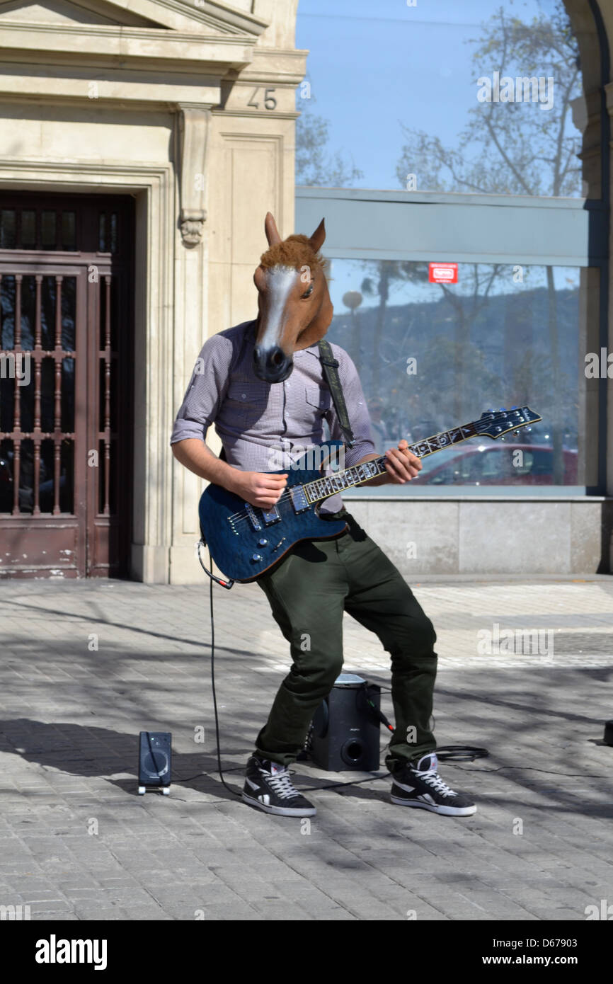 Street performer, guitarist with horse mask, Barceloneta, Barcelona ...