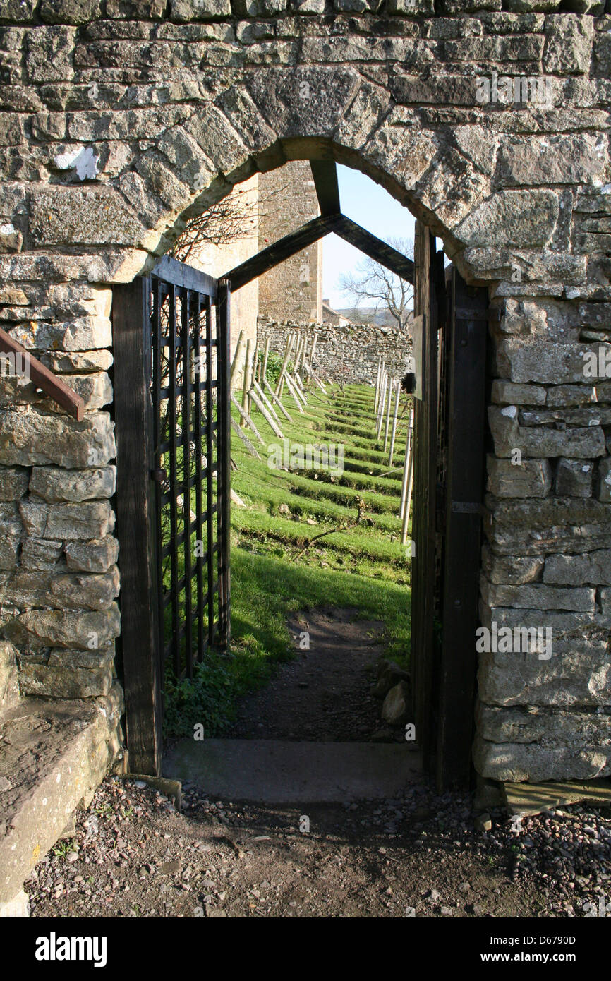 Stone gateway leading into the gardens of Bolton castle in Wensleydale ...