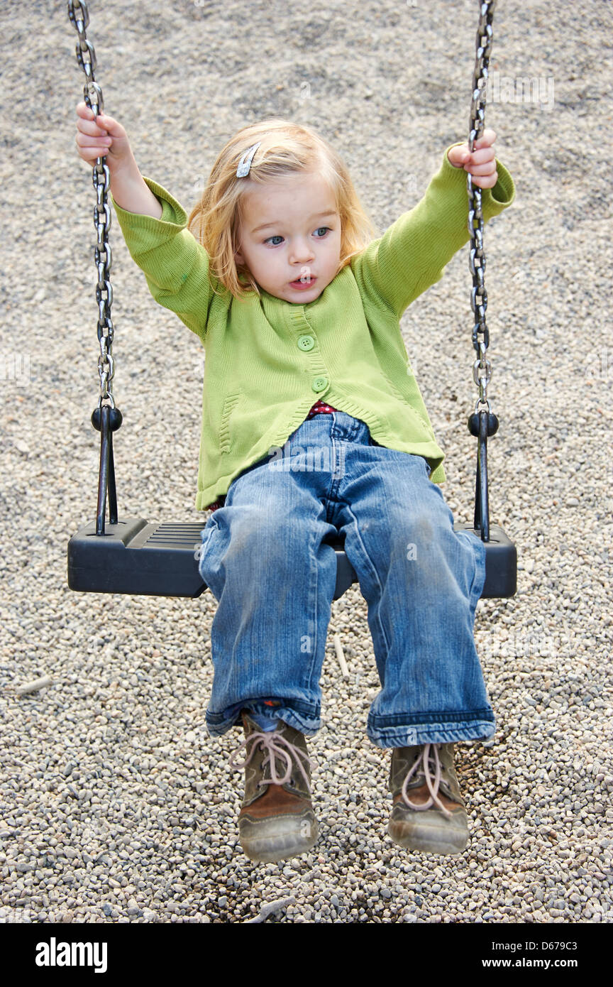 Baby child toddler blond girl on the swing - seesaw Stock Photo - Alamy