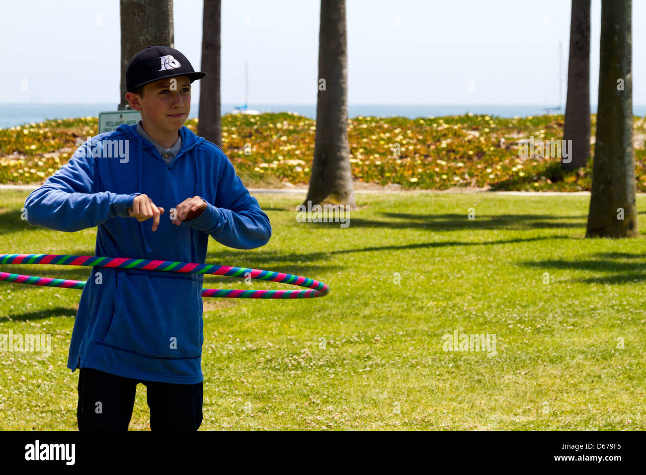 Young man demonstrating a hula hoop at the arts and crafts show in ...