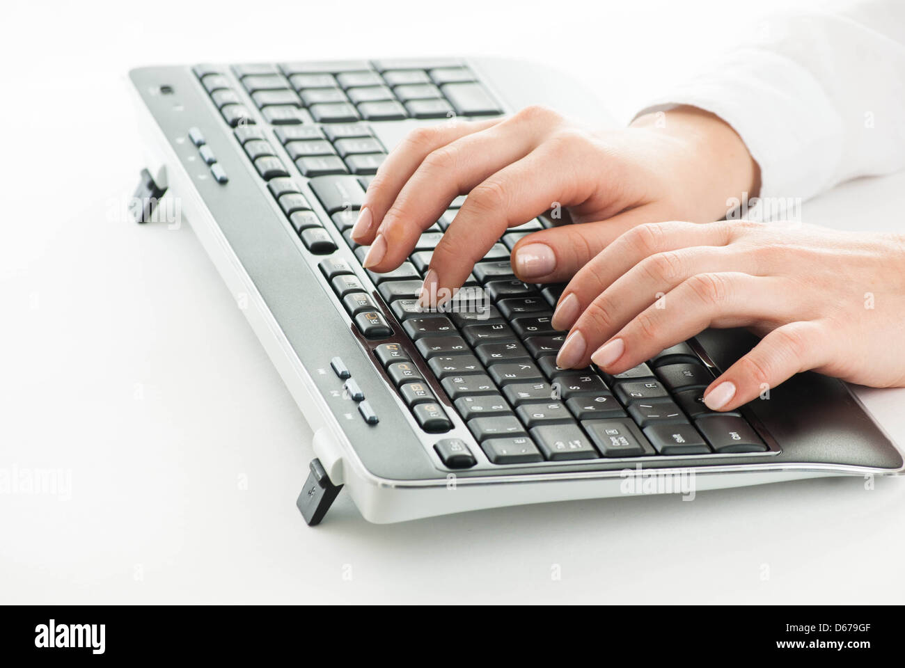 Hands on the black keyboard on the white background Stock Photo - Alamy